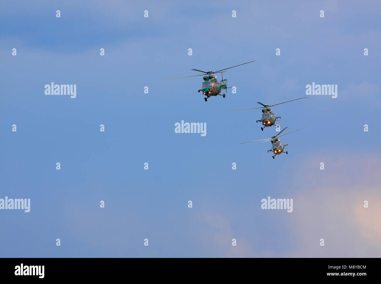 Three the Polish Air Force PZL W-3 Sokol (Falcon) flying over dark sky ...