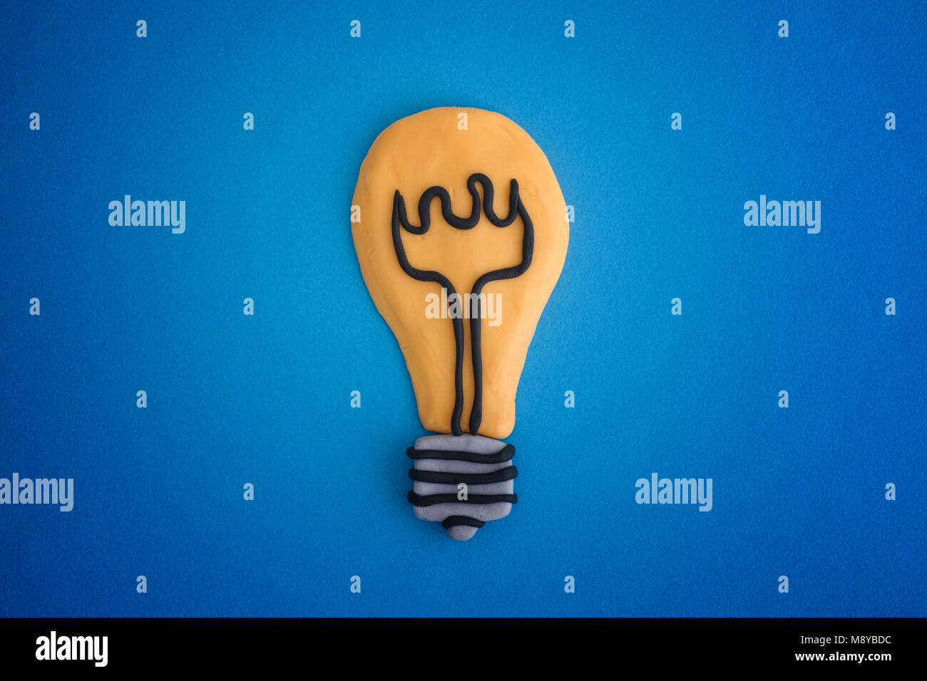 Light bulb made out of play clay on blue background. Idea concept ...