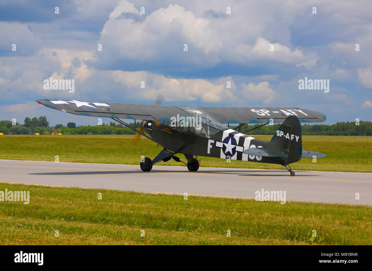 The Piper J-3 Cub (L-4 Grasshopper; military markings) on runway during ...