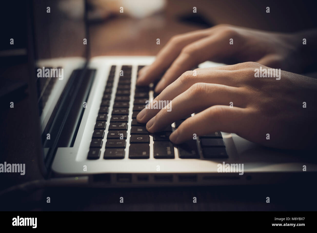 Hand typing on notebook keyboard Stock Photo - Alamy