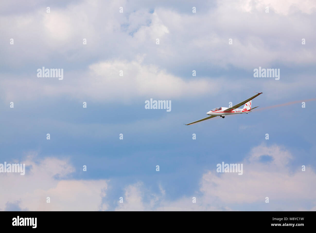 The MDM-1 Fox glider of the Zelazny Aerobatic Team flying over cloudy ...