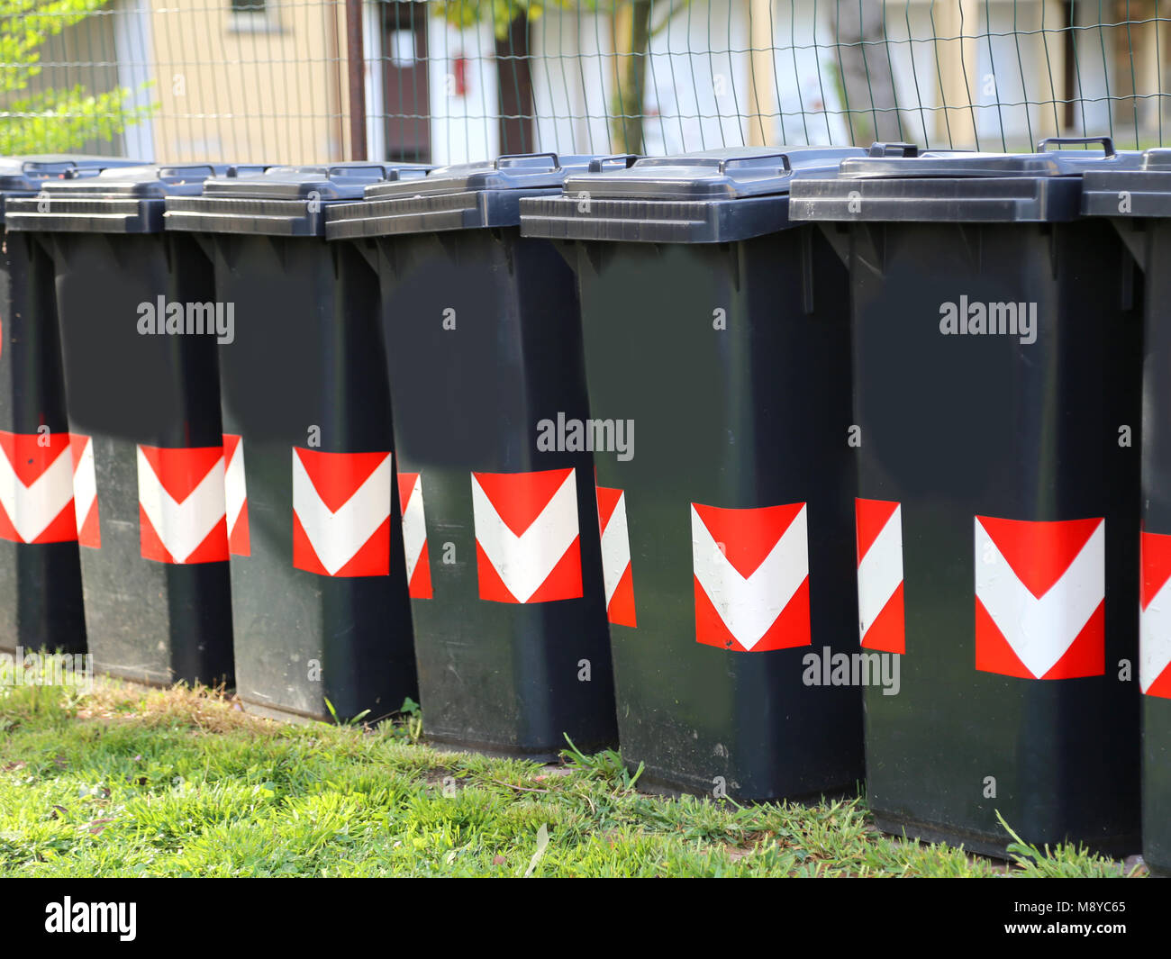 series of garbage cans in a condominium yard for the separate ...
