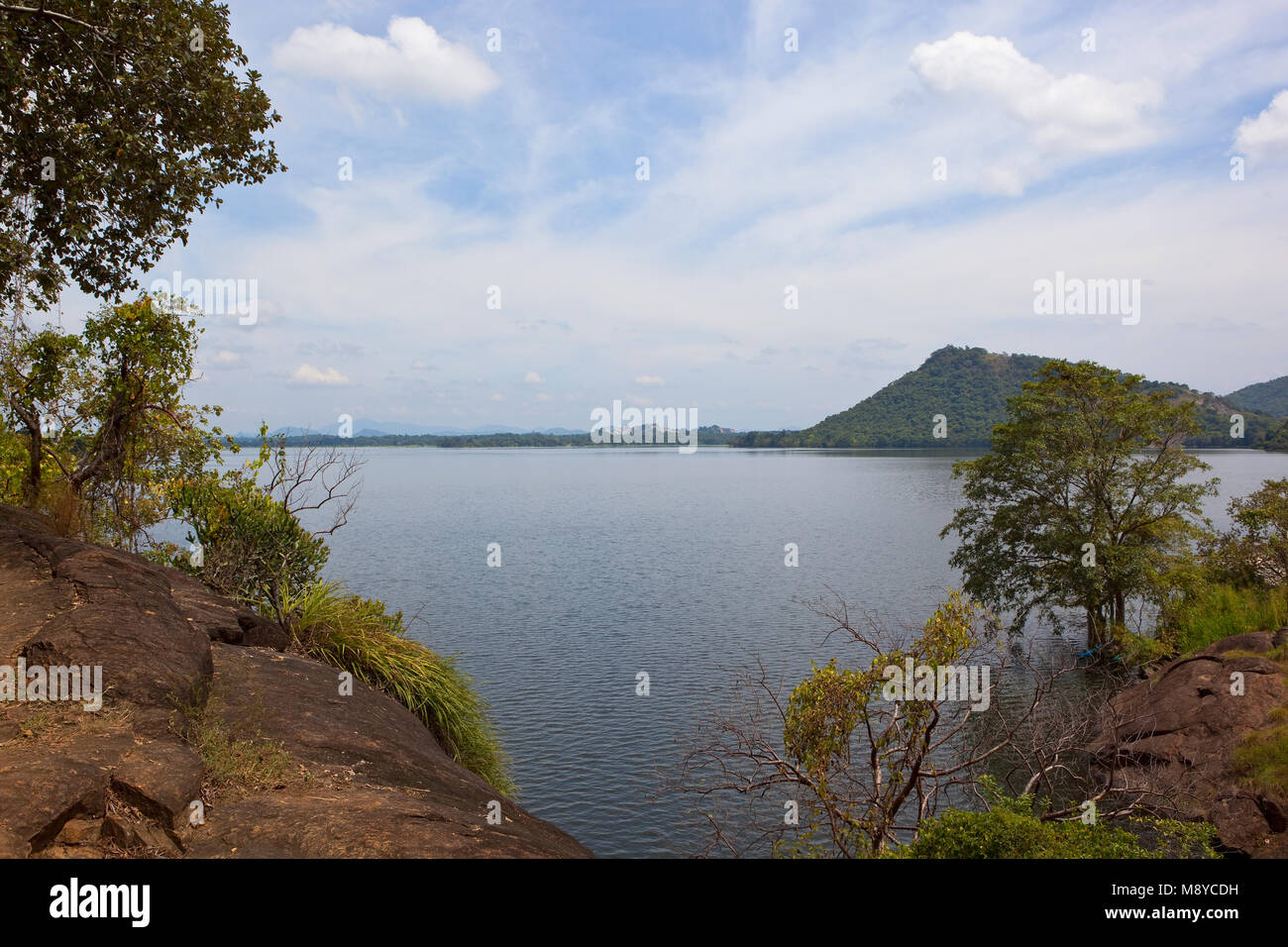 sri lankan sorabora lake with wooded hills and rock formations at a ...