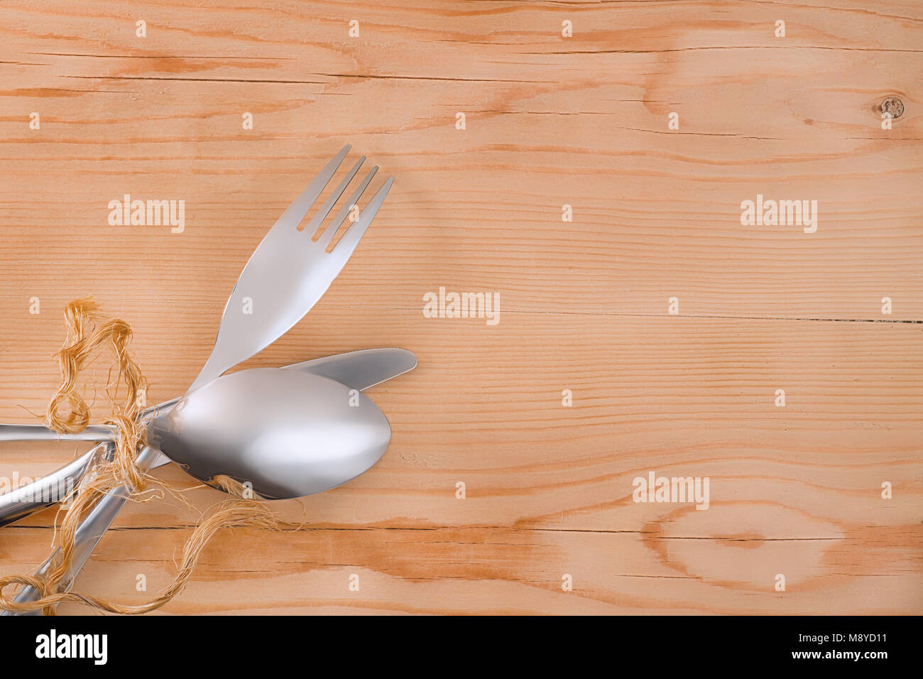Cutlery on wooden surface. Fork, knife and spoon laying on the wooden ...