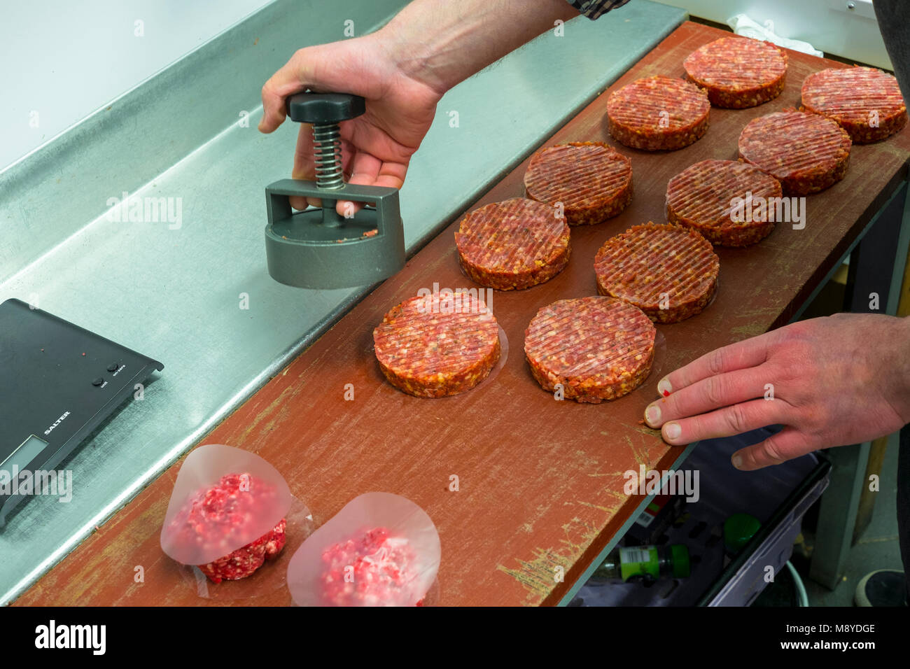 Butcher making burgers Stock Photo - Alamy