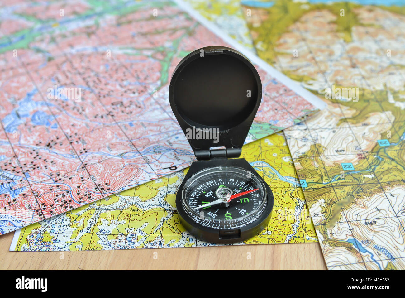 Maps and compass. Planning a trip, laying a route Stock Photo - Alamy