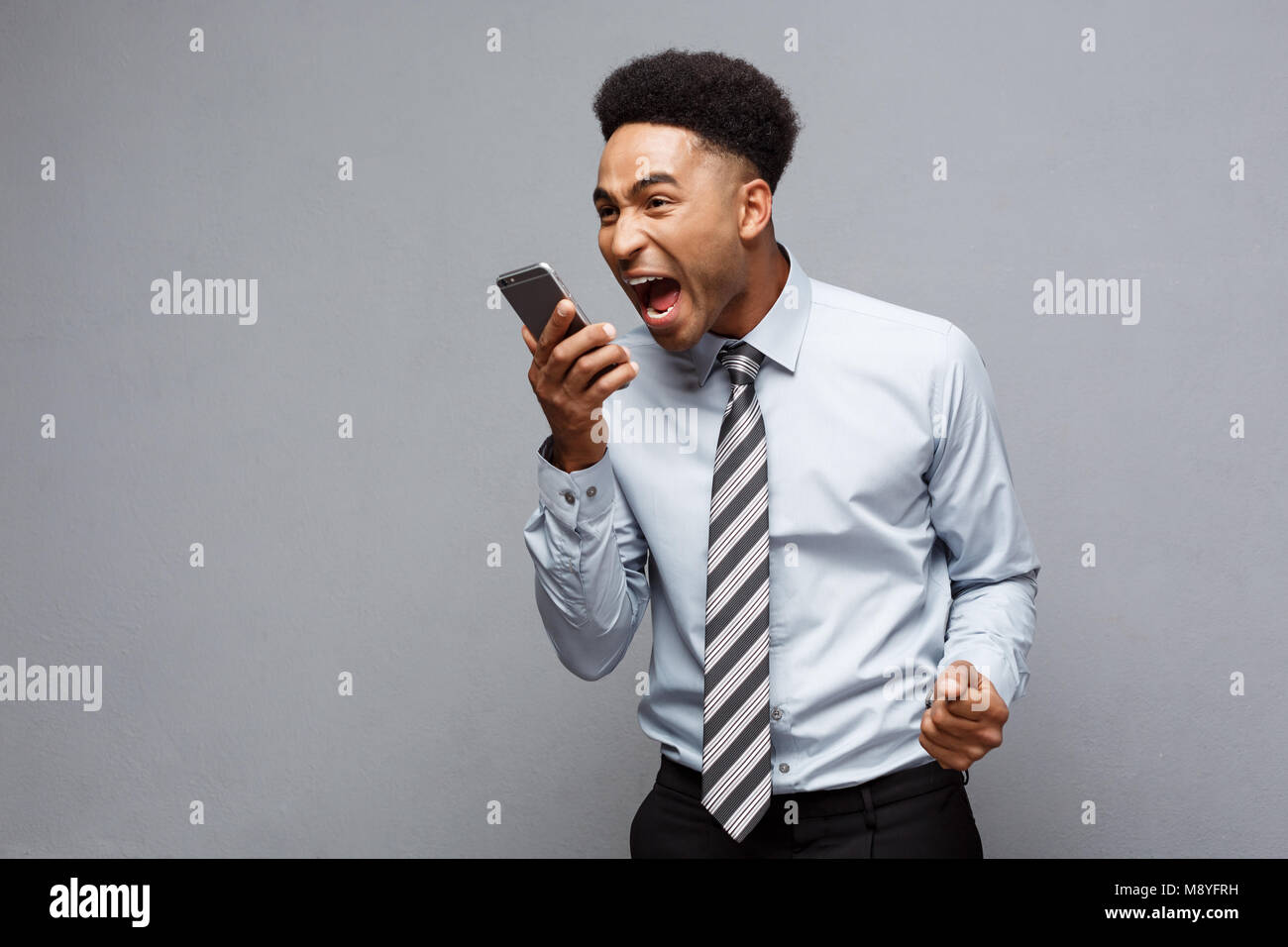 Business Concept - Stressful african american businessman shouting and ...