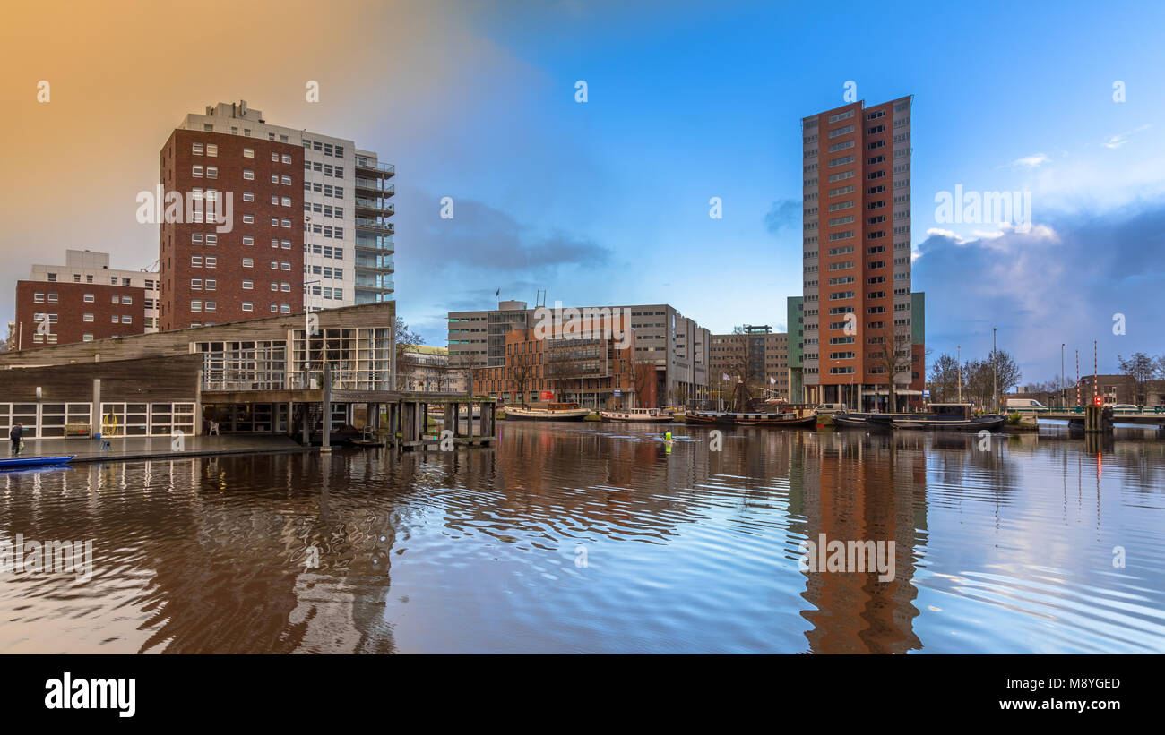 Modern buildings under orange sunset sky on the Zuiderhaven Groningen ...