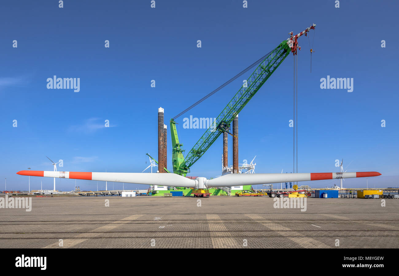 Offshore wind energy turbine supply vessel anchored and loading rotor ...