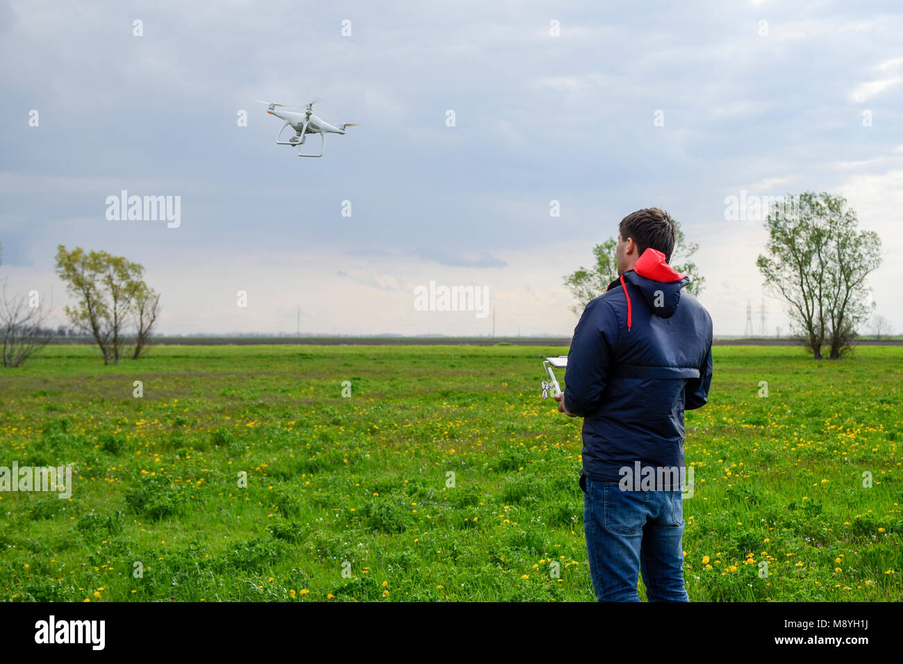 A man with a remote control in his hands. Flight control of the drone ...