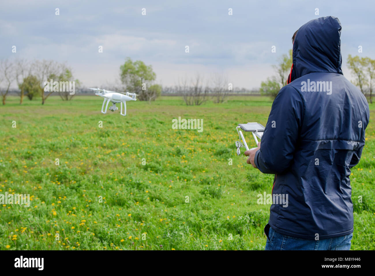 A man with a remote control in his hands. Flight control of the drone ...