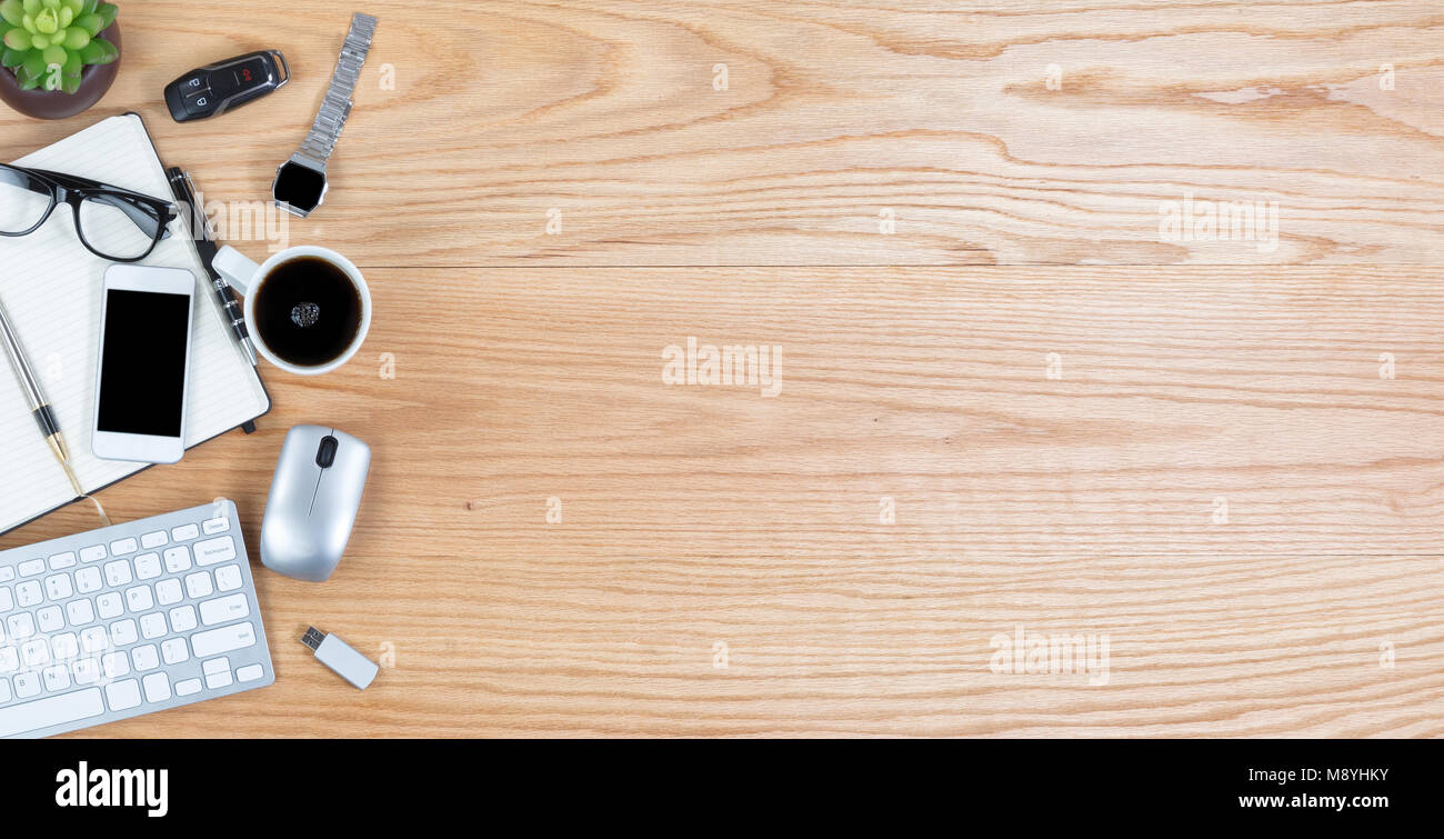 Top view of red oak desktop with technology and coffee on left hand ...