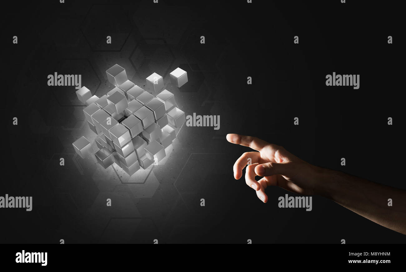 Close of man hand holding cube figure as symbol of innovation. Mixed ...