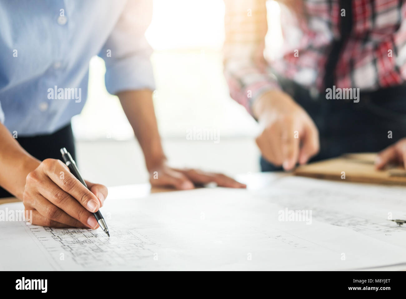 Close-up Of Person's engineer Hand Drawing Plan On Blue Print with ...