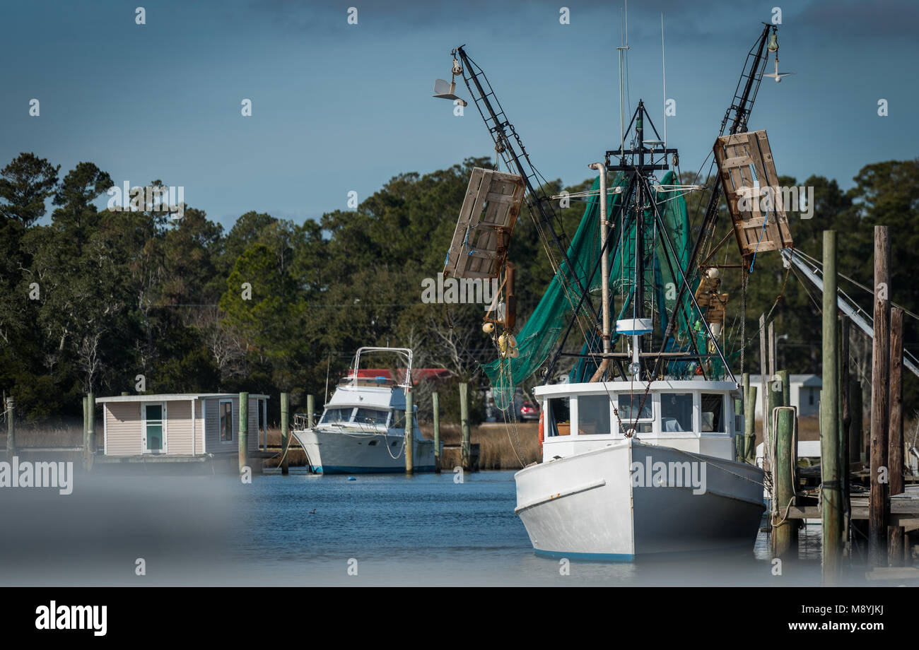 wooden fishing boats at piers at the coast of North Carolina with ...