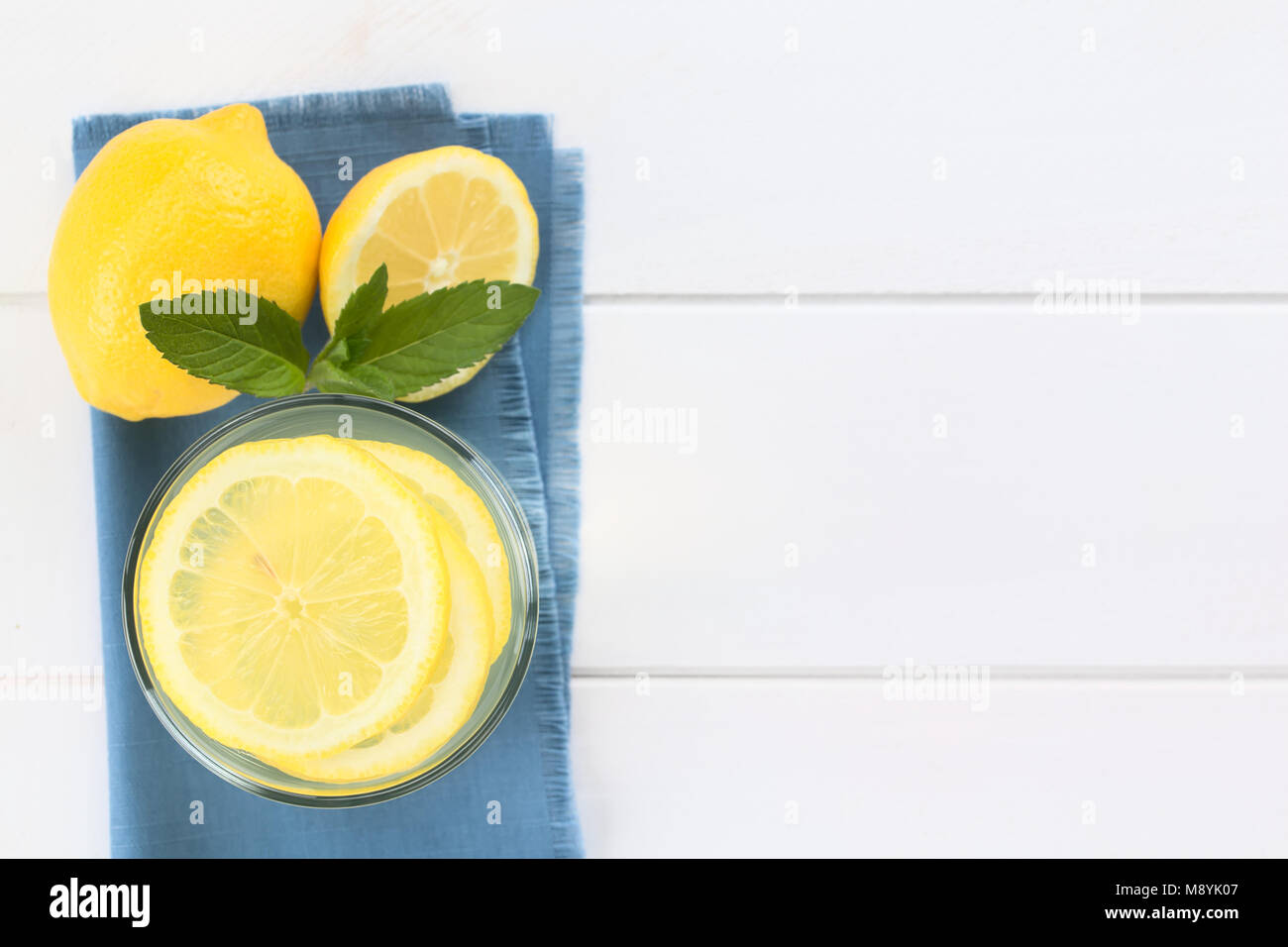 Fresh homemade lemonade or lemon water, photographed overhead on white ...