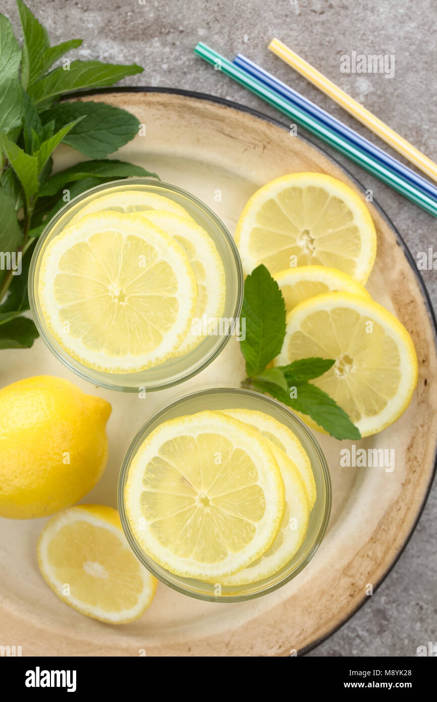 Fresh homemade lemonade or lemon water photographed overhead (Selective ...