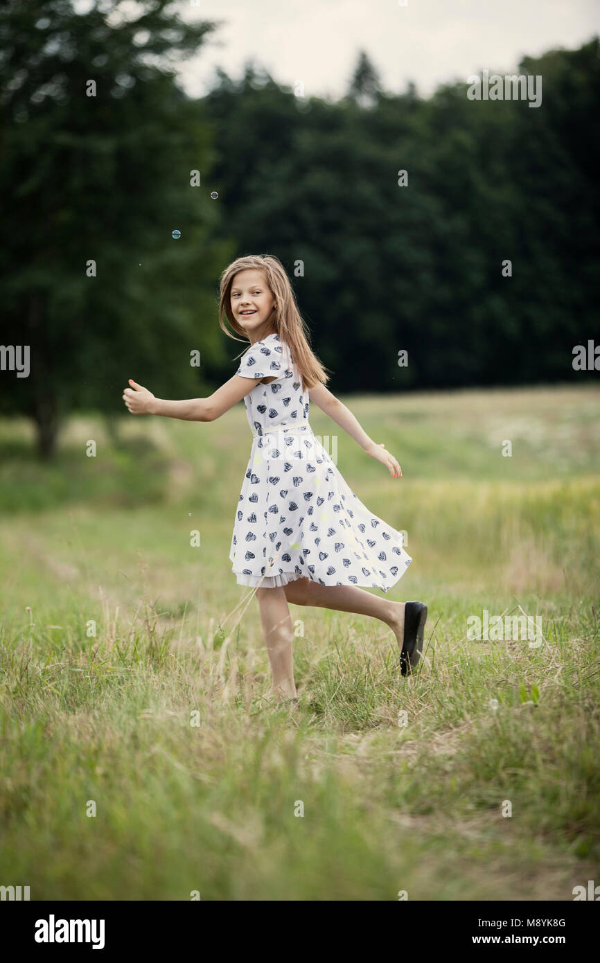 Girl having fun in the field Stock Photo - Alamy