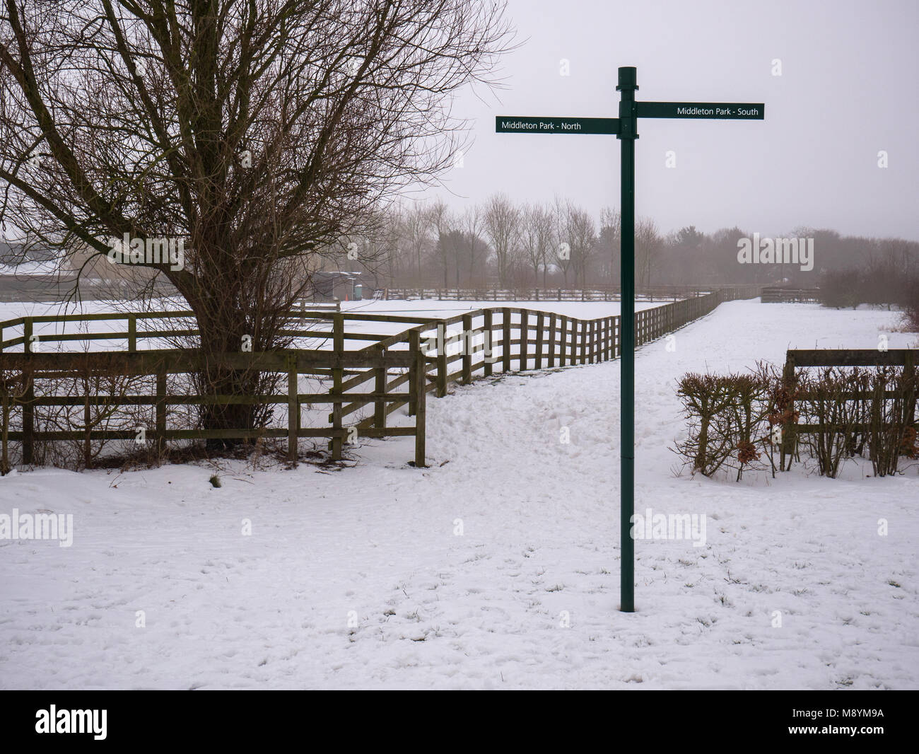 A signpost in a village setting, in the snow Stock Photo - Alamy