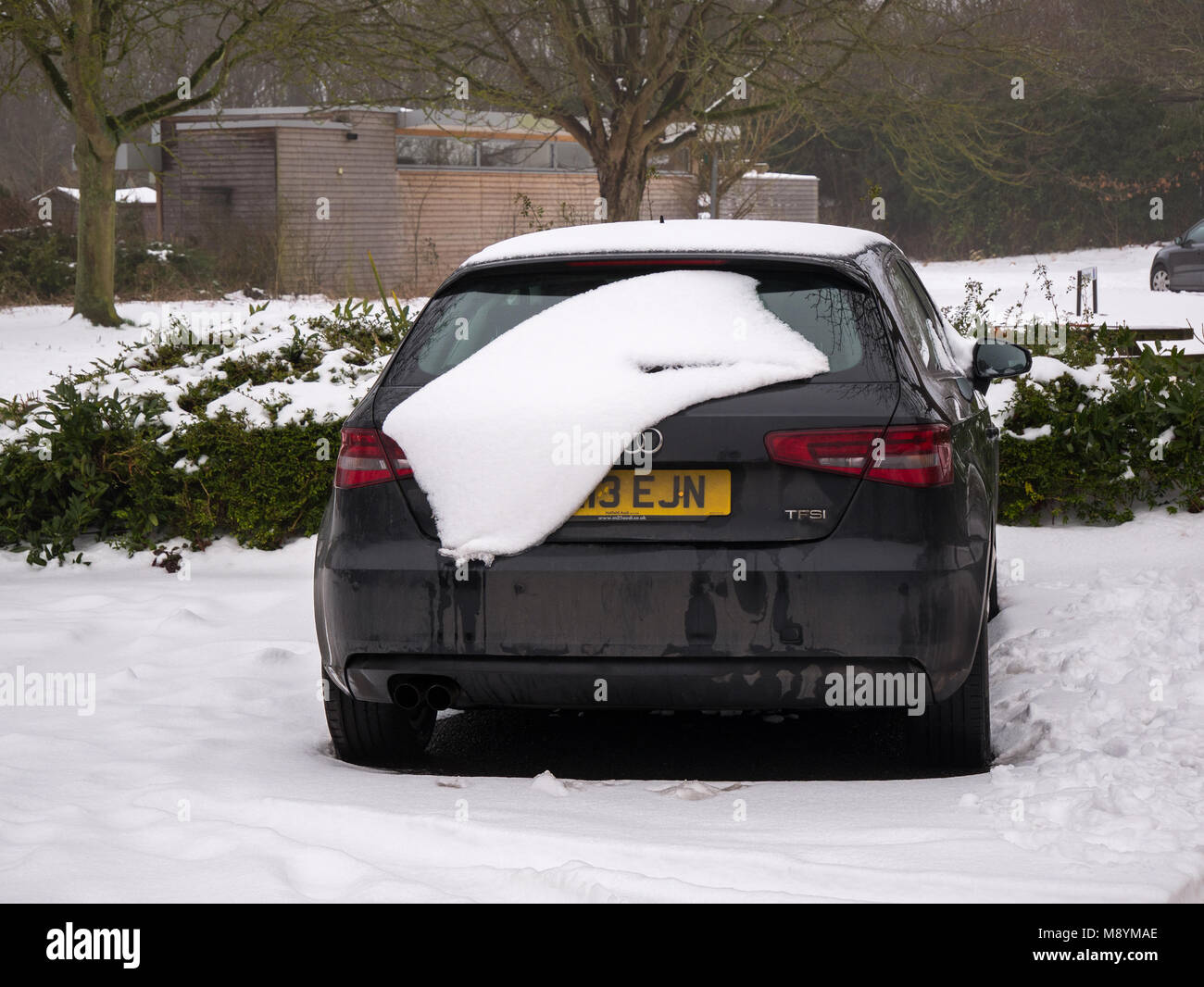 A rectangle of snow slipping off the back of a car window Stock Photo ...