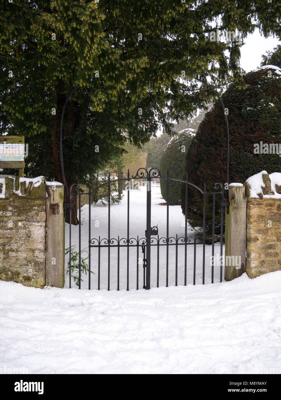 A pair of ornate wrought iron church gates in the snow Stock Photo - Alamy