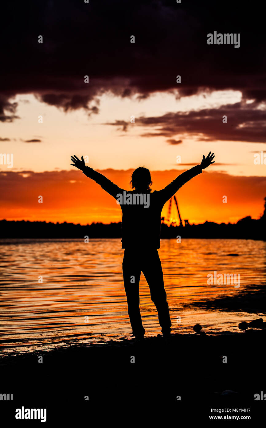 Silhouette of Man Raising His Hands or Open arms when sun rising up ...