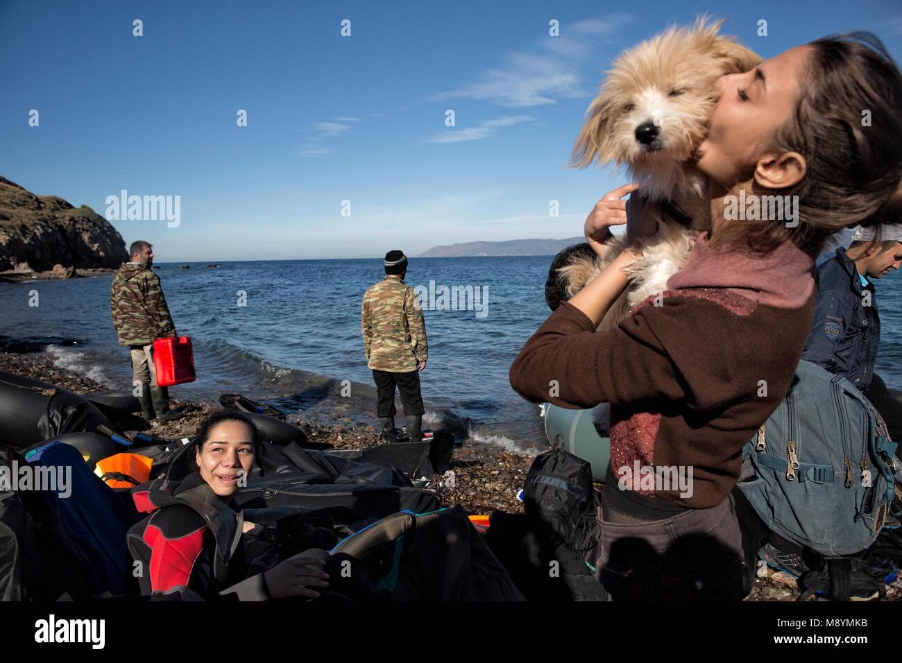 A Syrian girl from Aleppo kisses her dog after she and her family ...