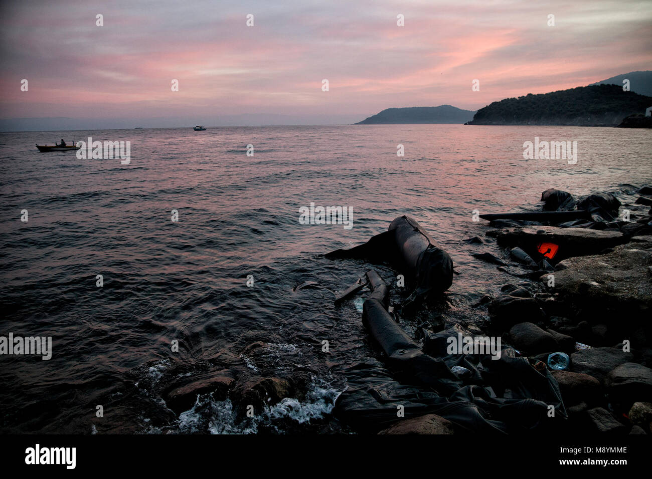 Deflated rubber boats and other debris along the shoreline left by ...