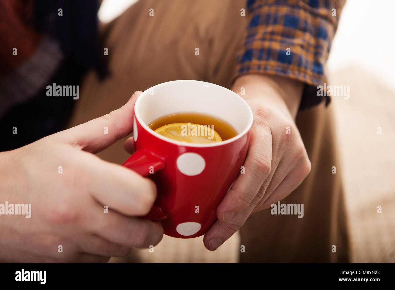 Close-up of male hands holding red mug Stock Photo - Alamy