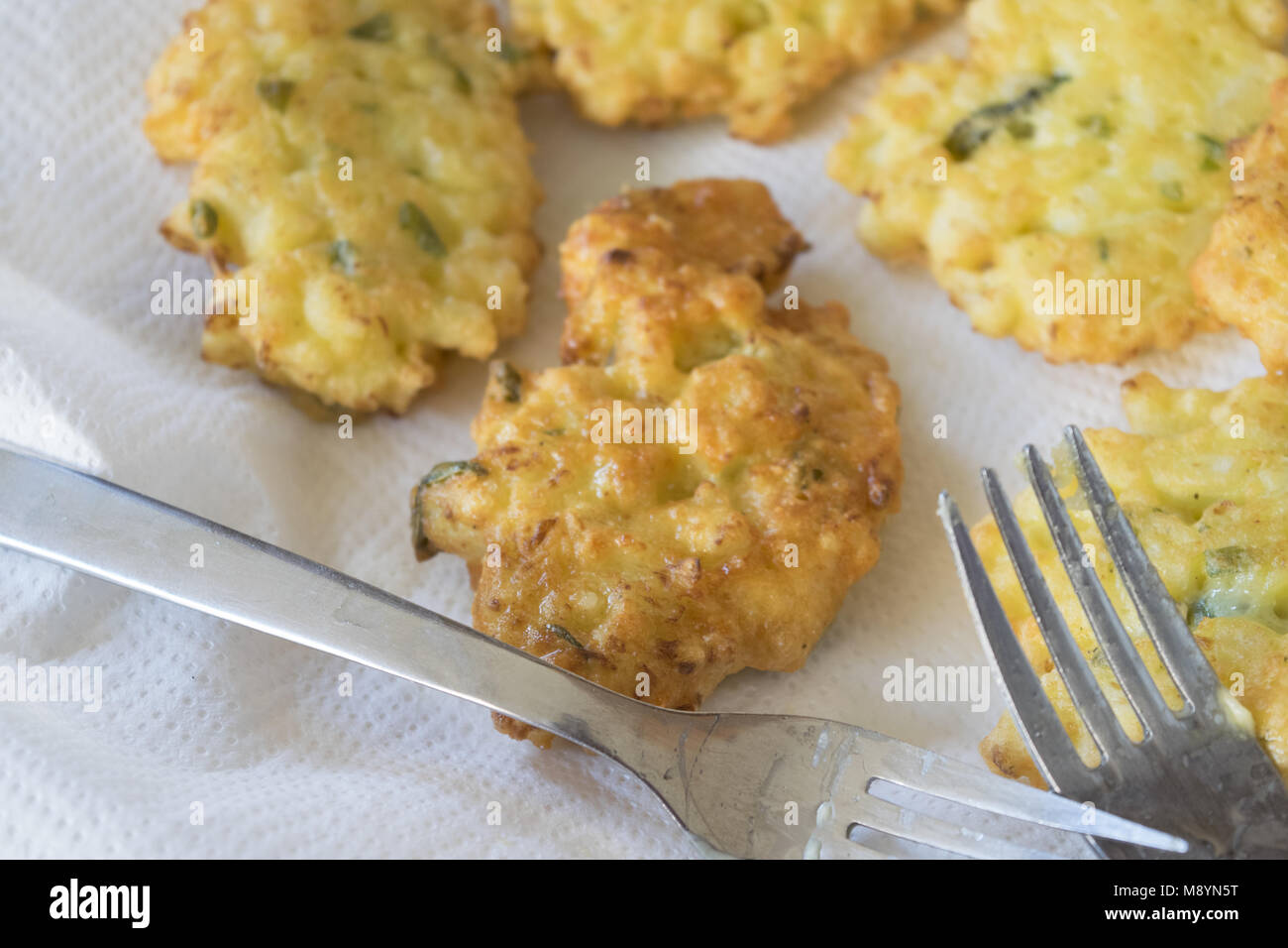 vegetarian crispy fritters just fried and disposed on absorbent kitchen ...