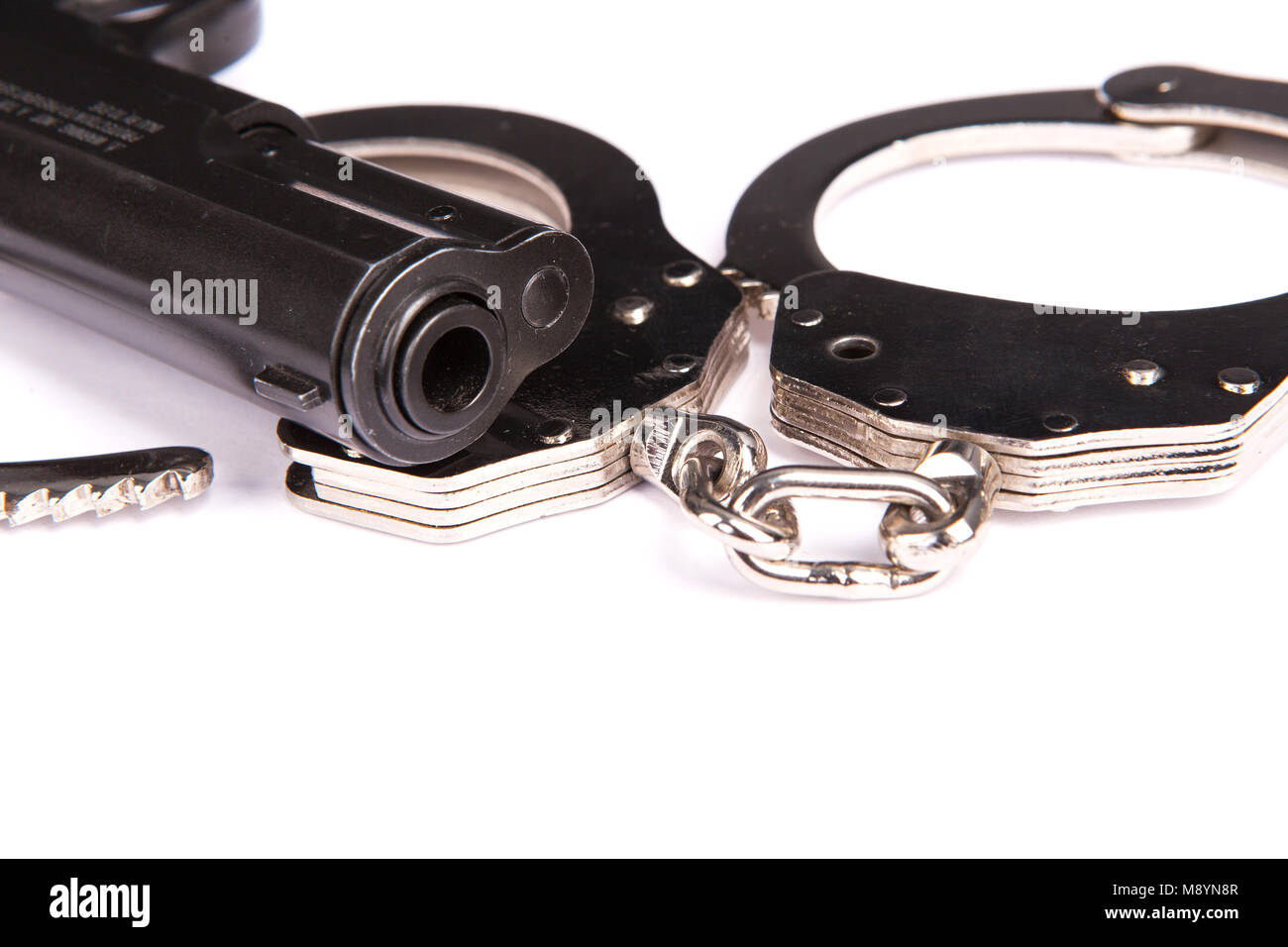 police handcuffs with a gun isolated on a white background Stock Photo ...