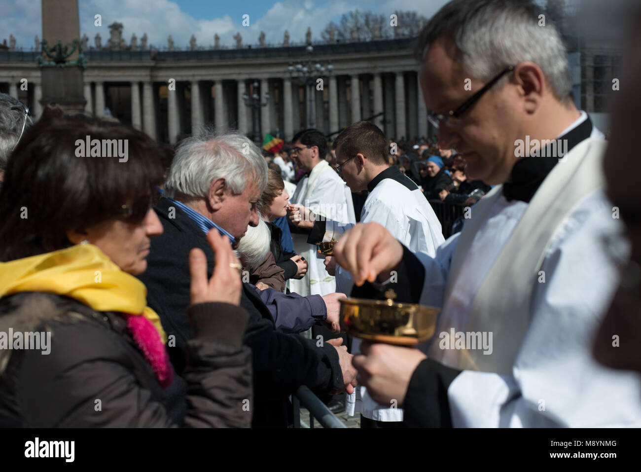 Vatican City. Faithfuls receive communion during the inauguration mass ...