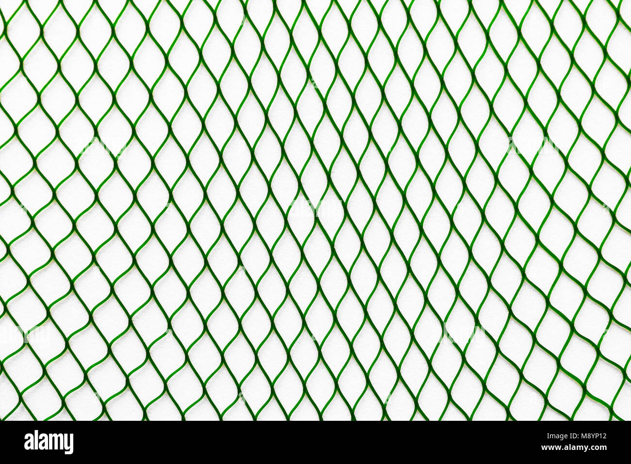 Green net placed vertically on the white soft background surface Stock ...