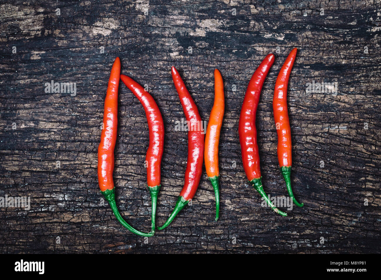Red Hot Chili Peppers on rustic wooden top view Stock Photo - Alamy