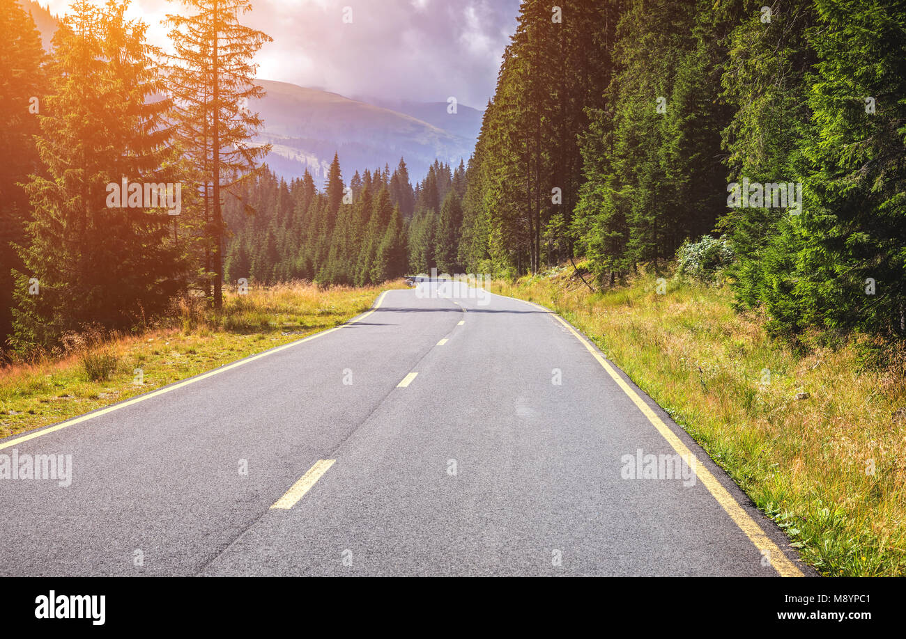 Mountain road. Landscape with rocks, sunny sky with clouds and ...
