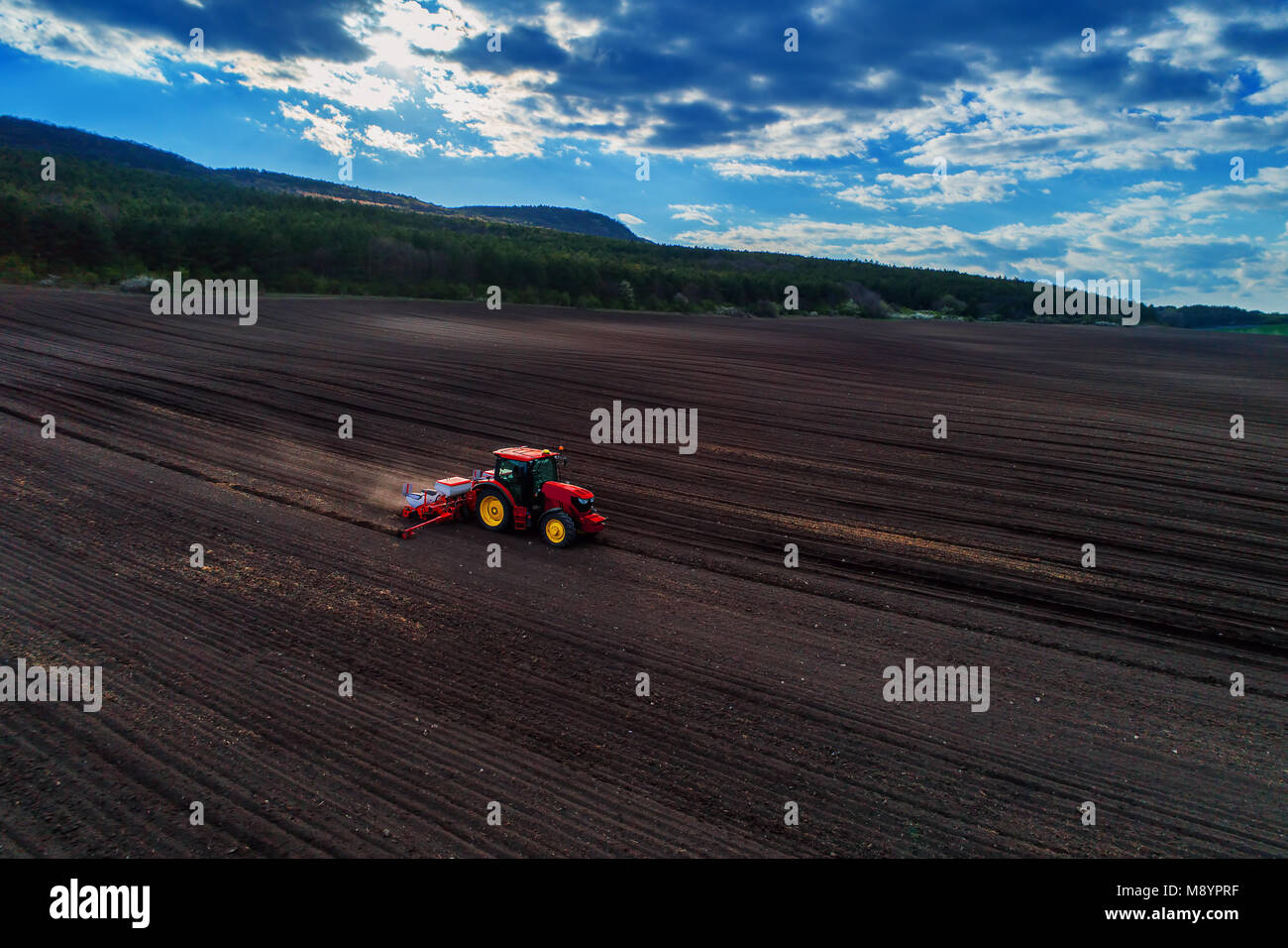 Agriculture - aerial view of harvest fields with tractor Stock Photo ...