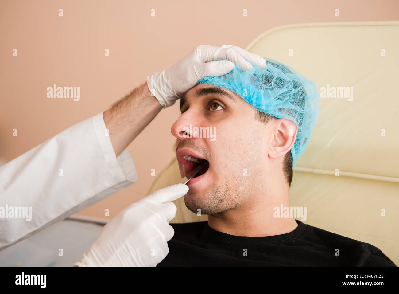 Ent specialist doctor examining patient hi-res stock photography and ...