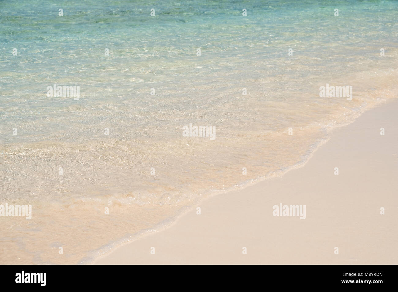 clear water on clean white sand beach closeup Stock Photo - Alamy