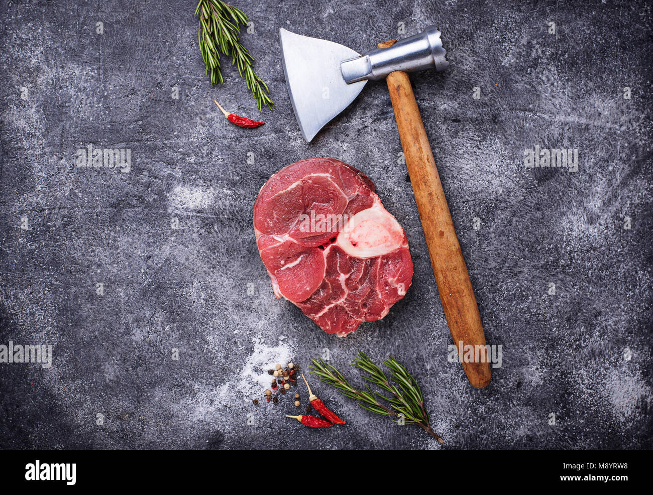Raw meat osso buco and butchers axe Stock Photo - Alamy