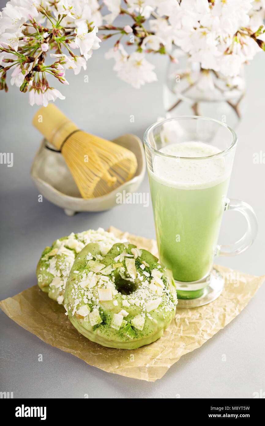 Matcha and white chocolate donuts with tea Stock Photo - Alamy