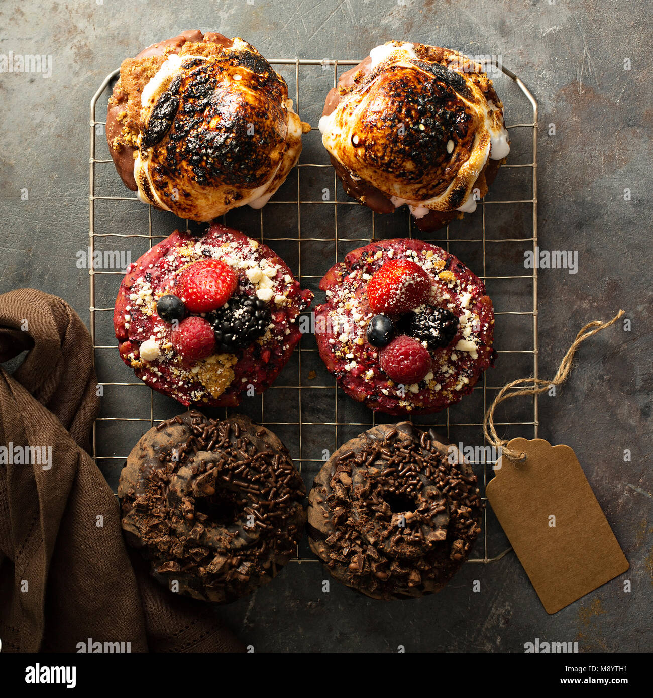 Variety of donuts on a cooling rack Stock Photo - Alamy