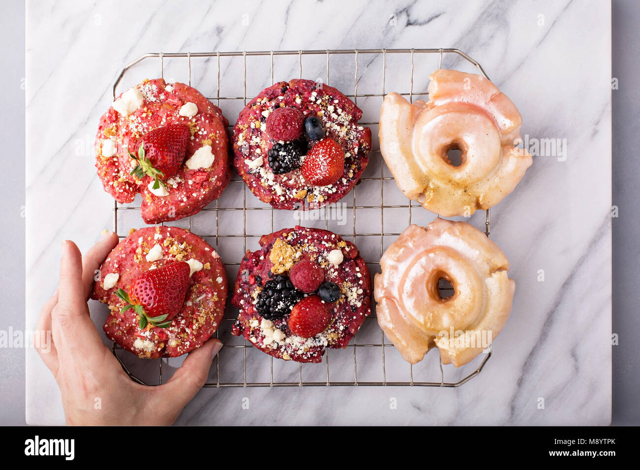 Variety of donuts on a cooling rack Stock Photo - Alamy