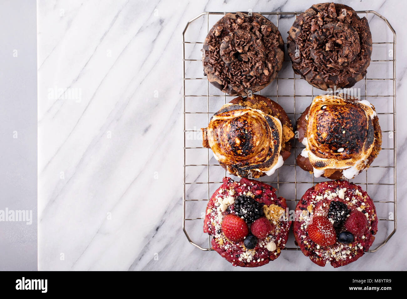 Variety of donuts on a cooling rack Stock Photo - Alamy