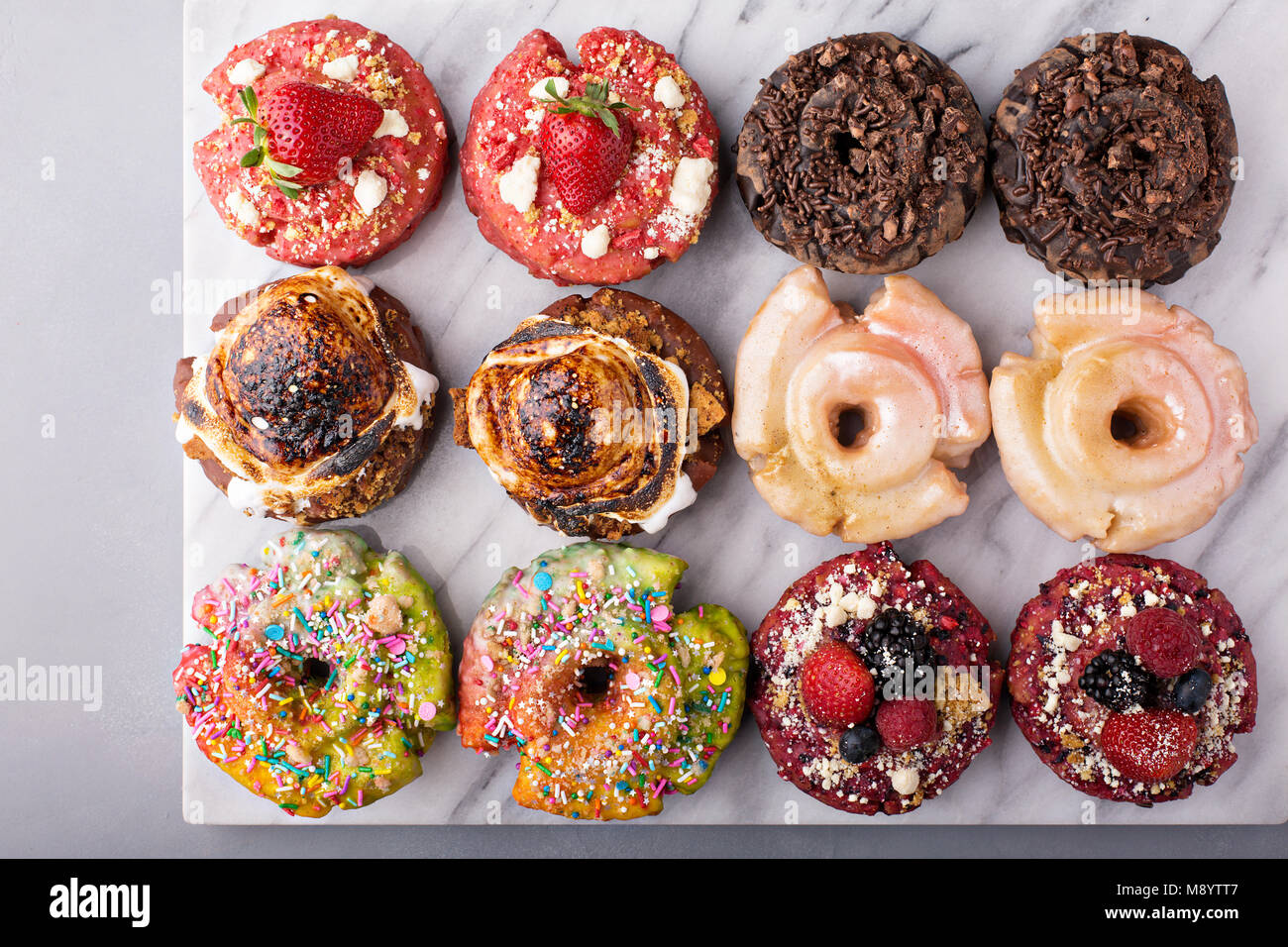 Variety of donuts on a marble surface Stock Photo - Alamy