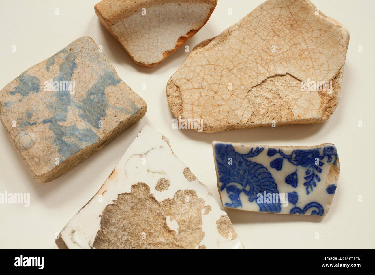 Broken pottery shards on a tabletop Stock Photo - Alamy