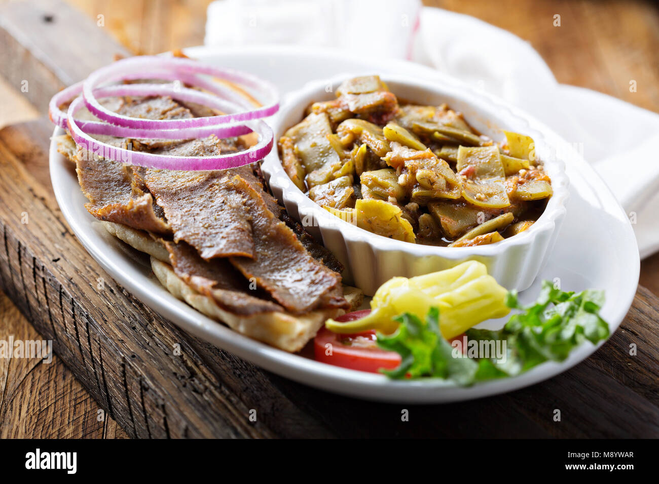Gyro plate with meat on a pita Stock Photo - Alamy