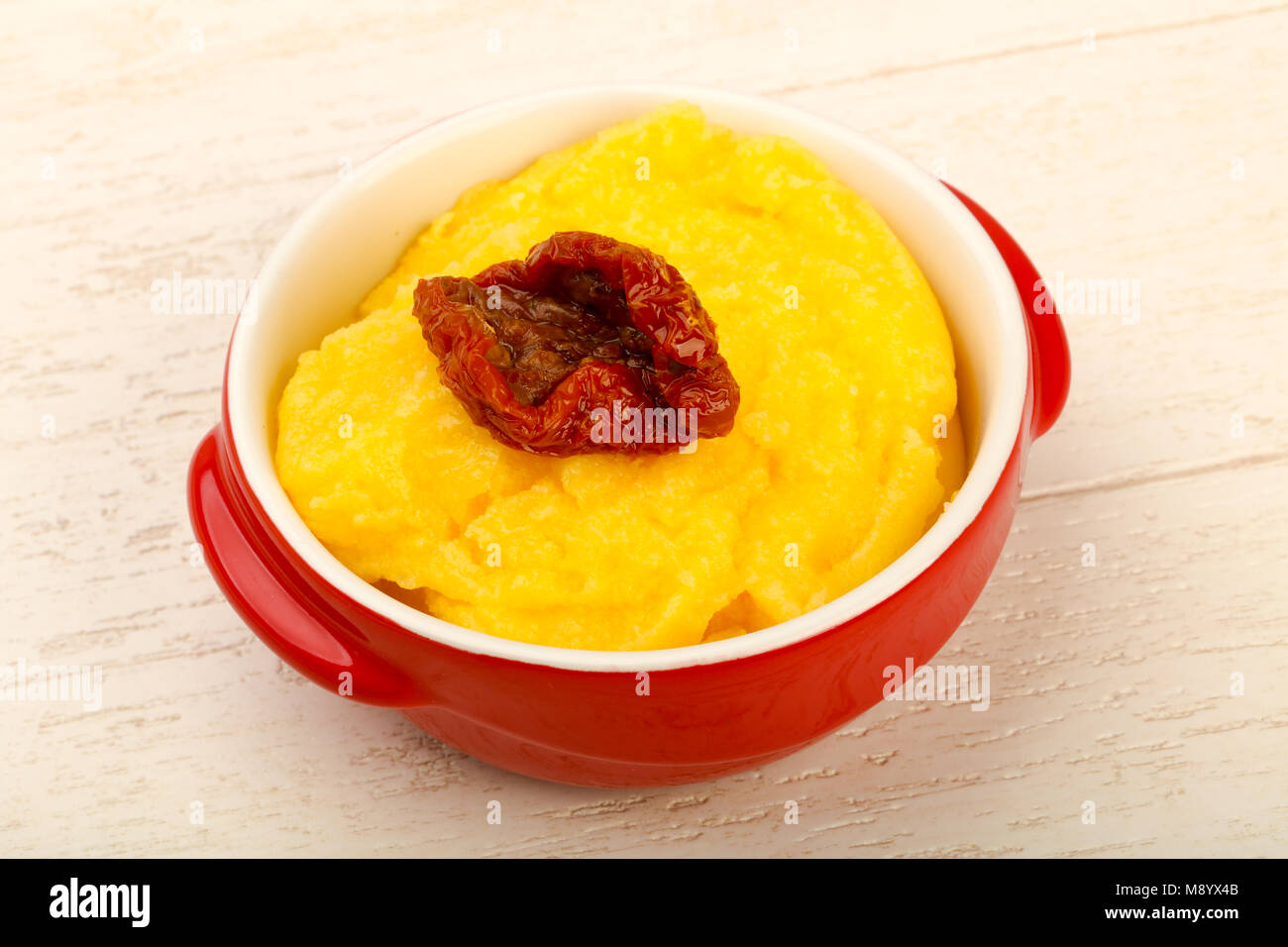 Polenta with dry tomato Stock Photo - Alamy