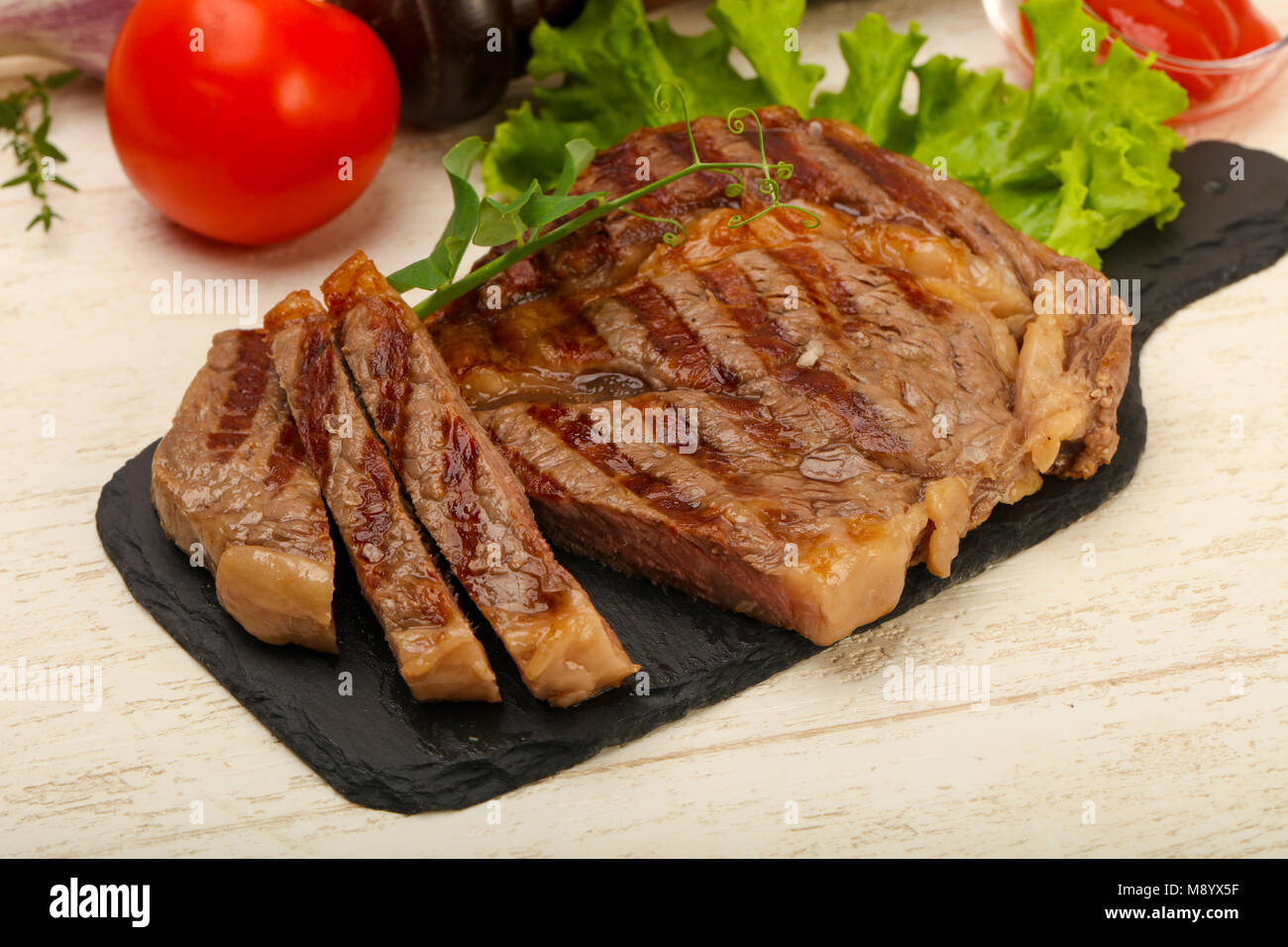 Grilled Rib eye steak with sauce Stock Photo - Alamy