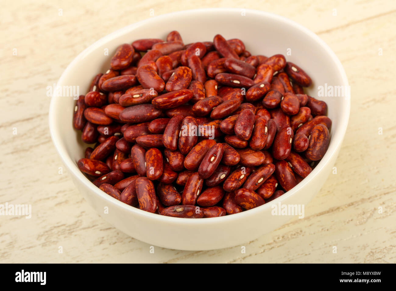 Dry beans in the bowl over wooden background Stock Photo - Alamy