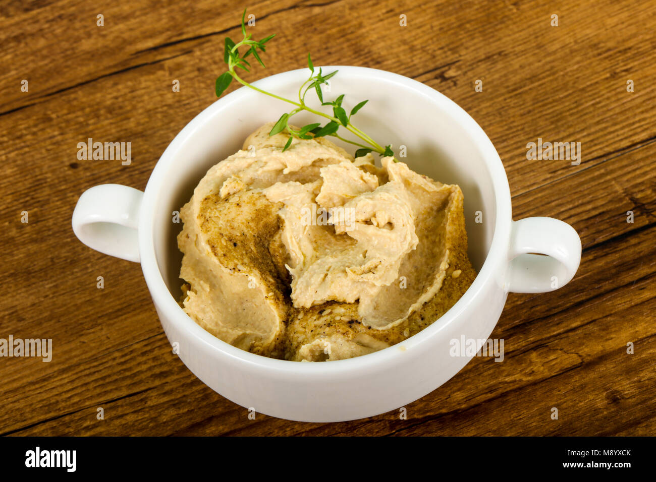 Vegetarian Humus with sesame seeds and thyme leaves Stock Photo - Alamy